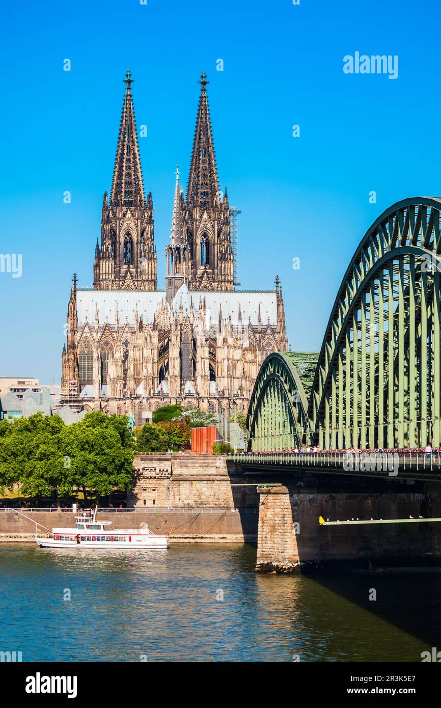 Cologne Cathedral and Hohenzollern Bridge through Rhine river in ...