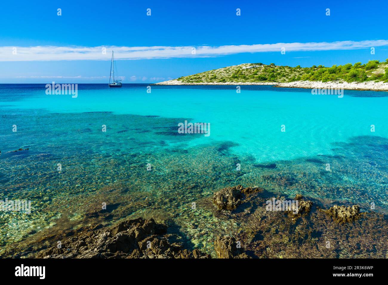 Bay on island in croatia with blue and turquoise water with sail boat ...
