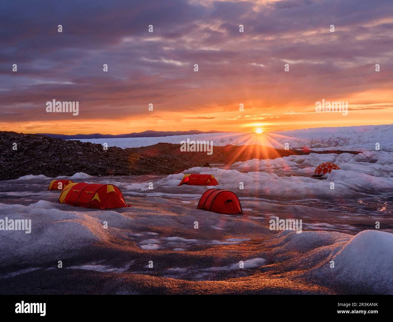 Camp with tents on the ice sheet. The brown sediment on the ice is ...