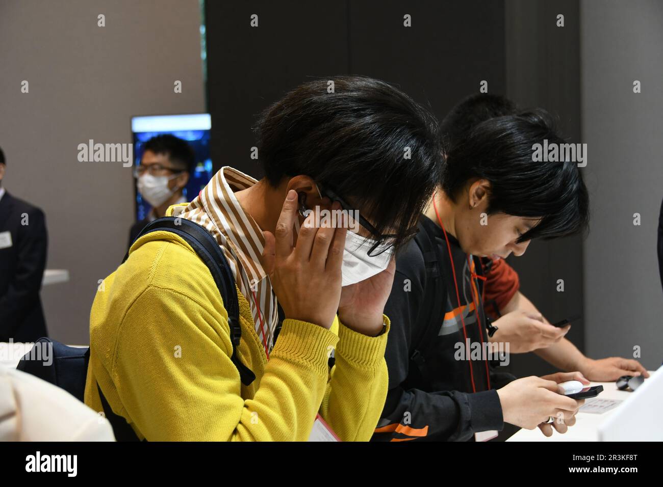 Tokyo, Japan. 24th May, 2023. A visitor tries wireless earbuds at the ...