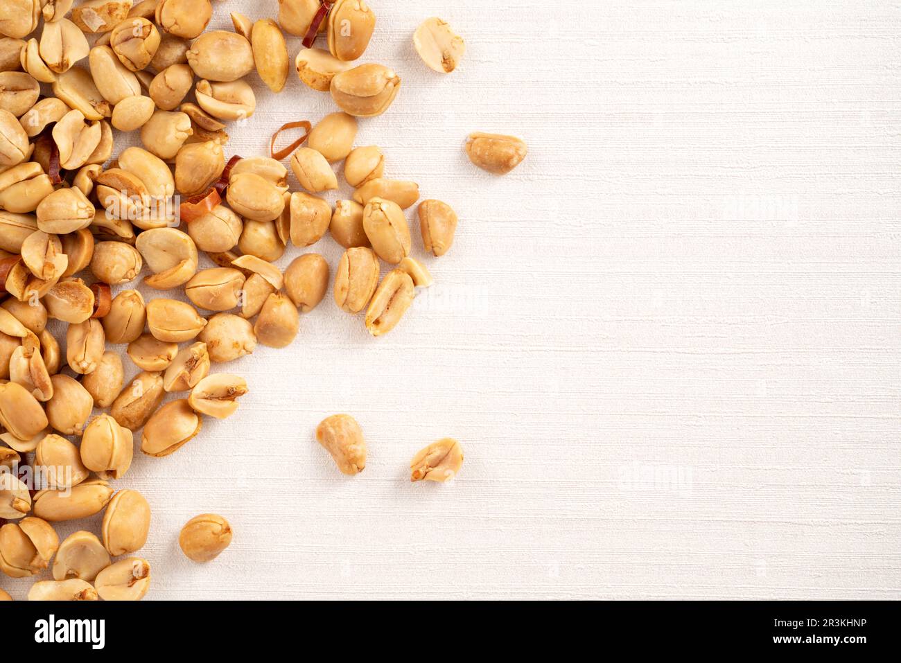 Spicy flavored peanut kernel spilling on white table background Stock ...