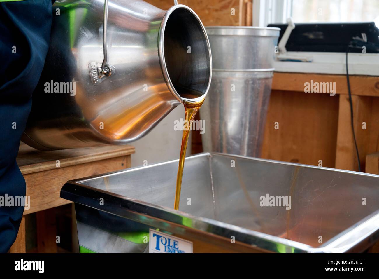 Making maple syrup, 2nd filtration, in a sugar shack in a maple grove ...