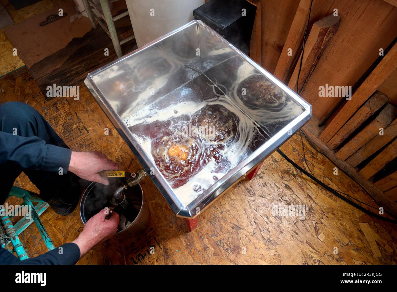 Making maple syrup, finishing syrup on a gas to refine the sugar ...