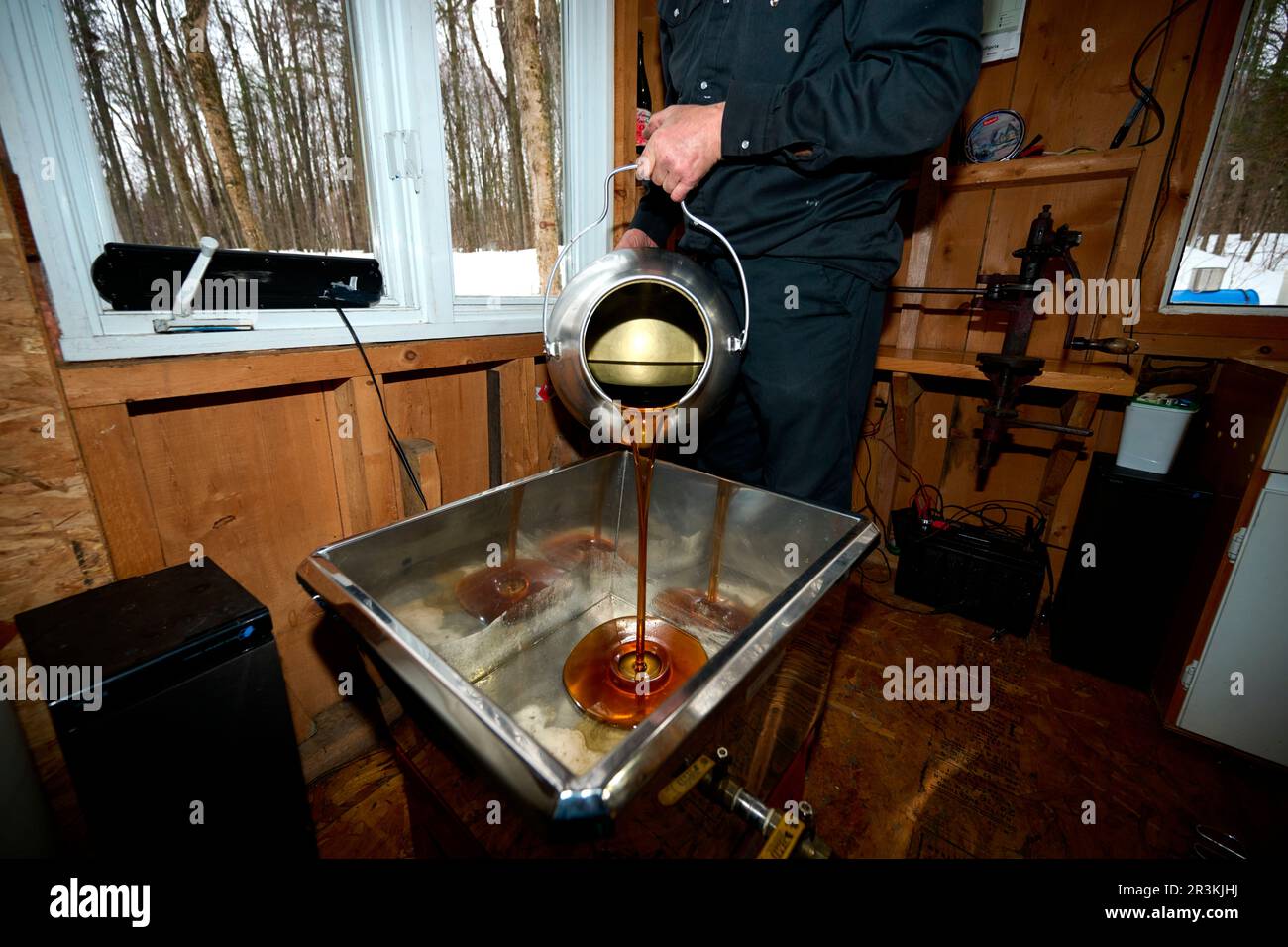 Making maple syrup in a sugar shack in a maple grove at sugar time ...