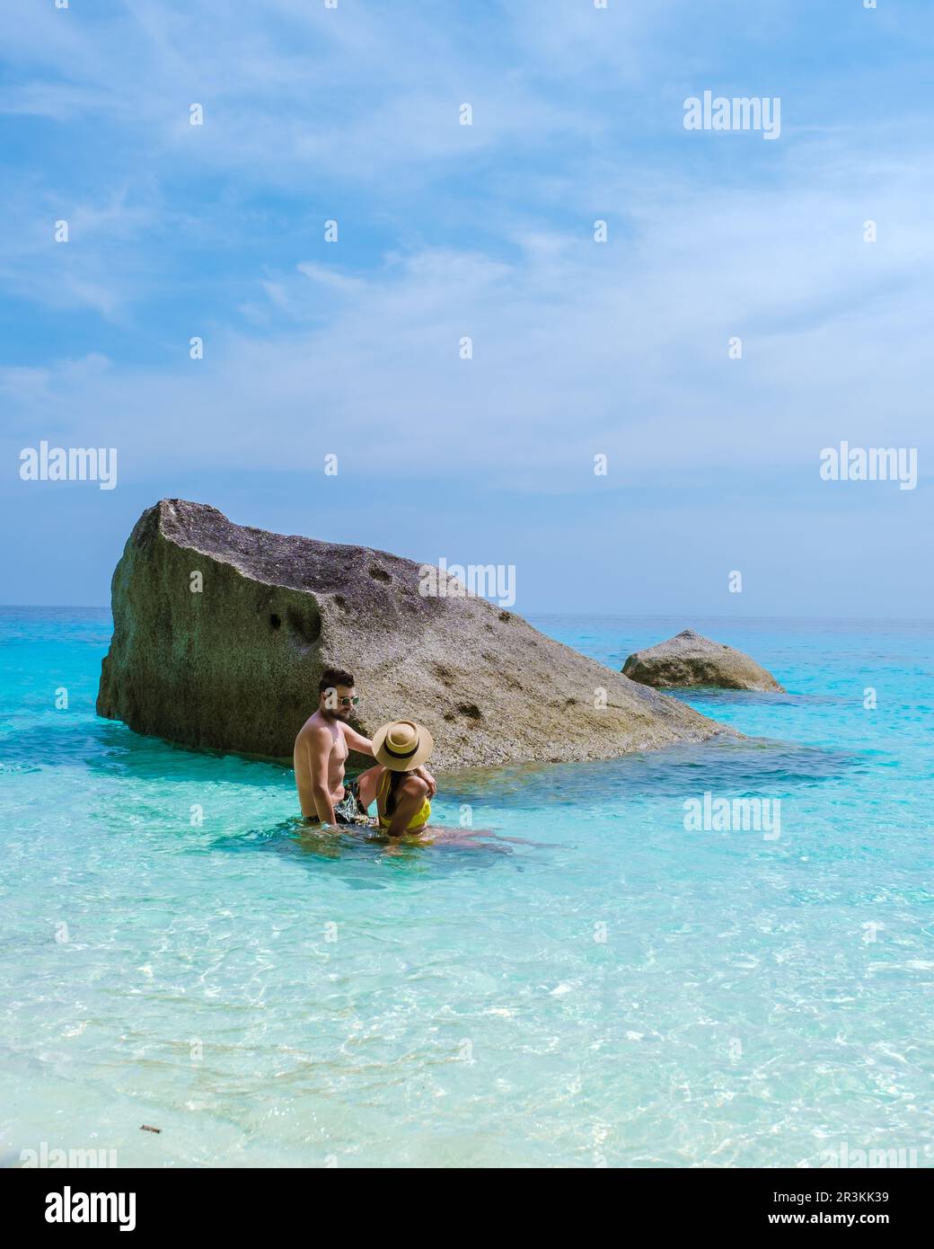 Men and women on the tropical white beach with turqouse colored ocean of Similan Islands ...