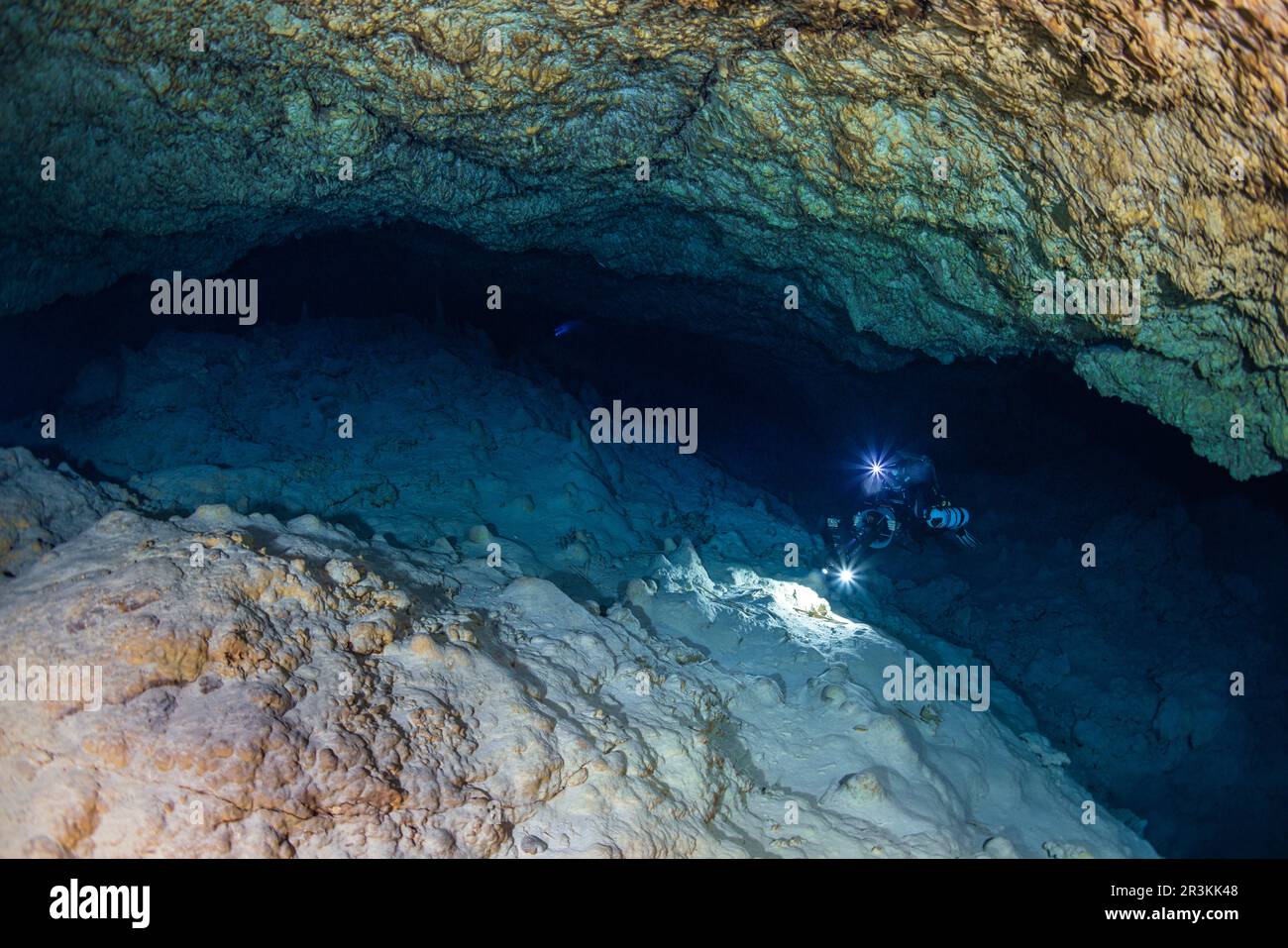 Diver at the bottom of an underwater cave 75 metres deep and which has ...