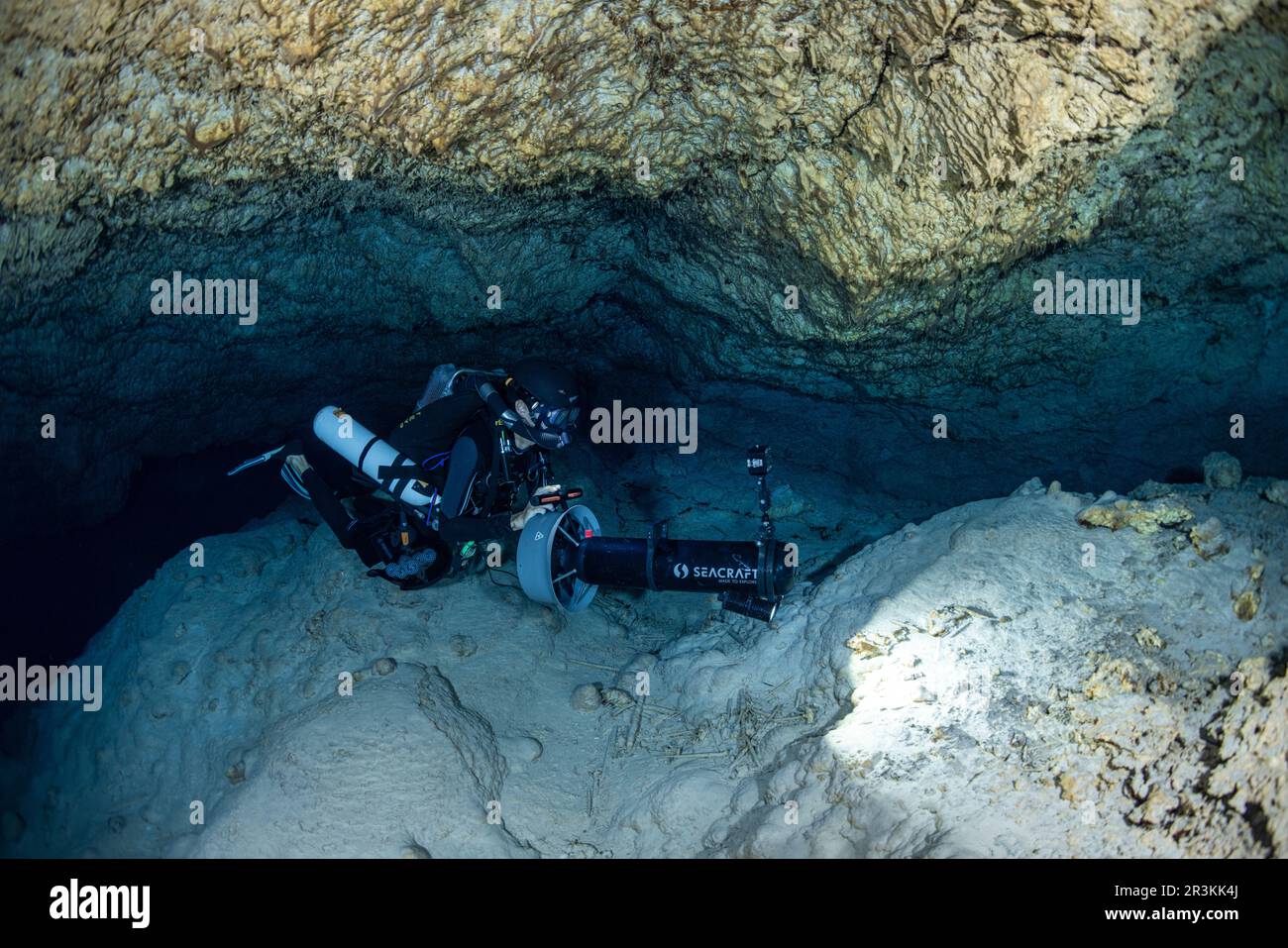Diver at the bottom of an underwater cave 75 metres deep and which has ...