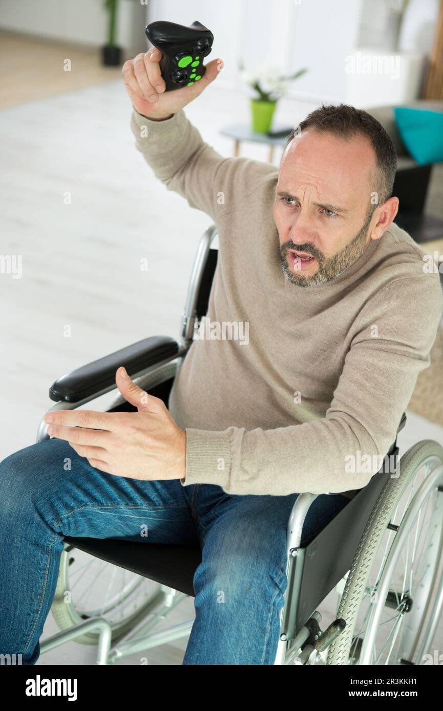 disabled man getting angry over computer game Stock Photo - Alamy