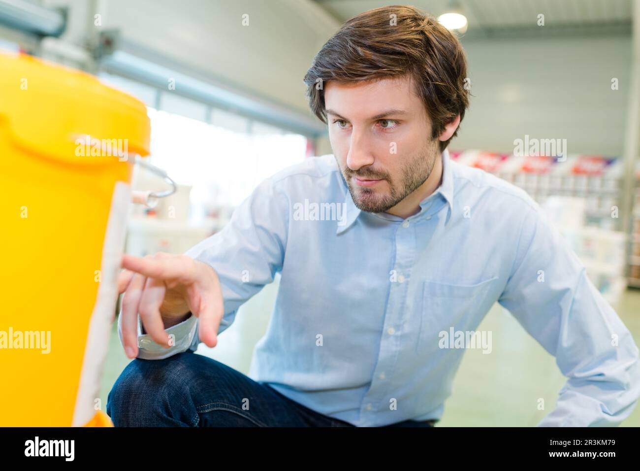 a man standing in front of a vending machine Stock Photo - Alamy