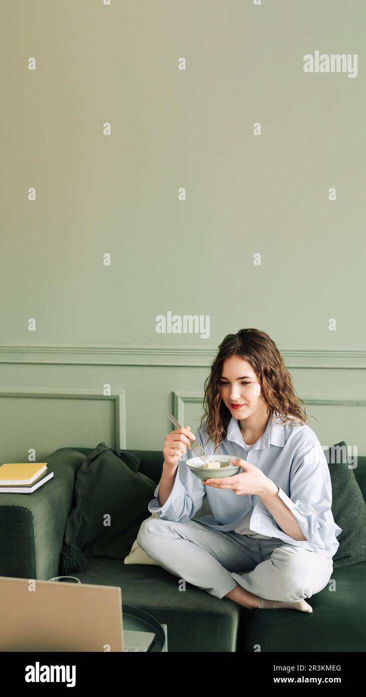 Relaxing weekend at home: Young woman in cozy clothes binge-watching TV ...