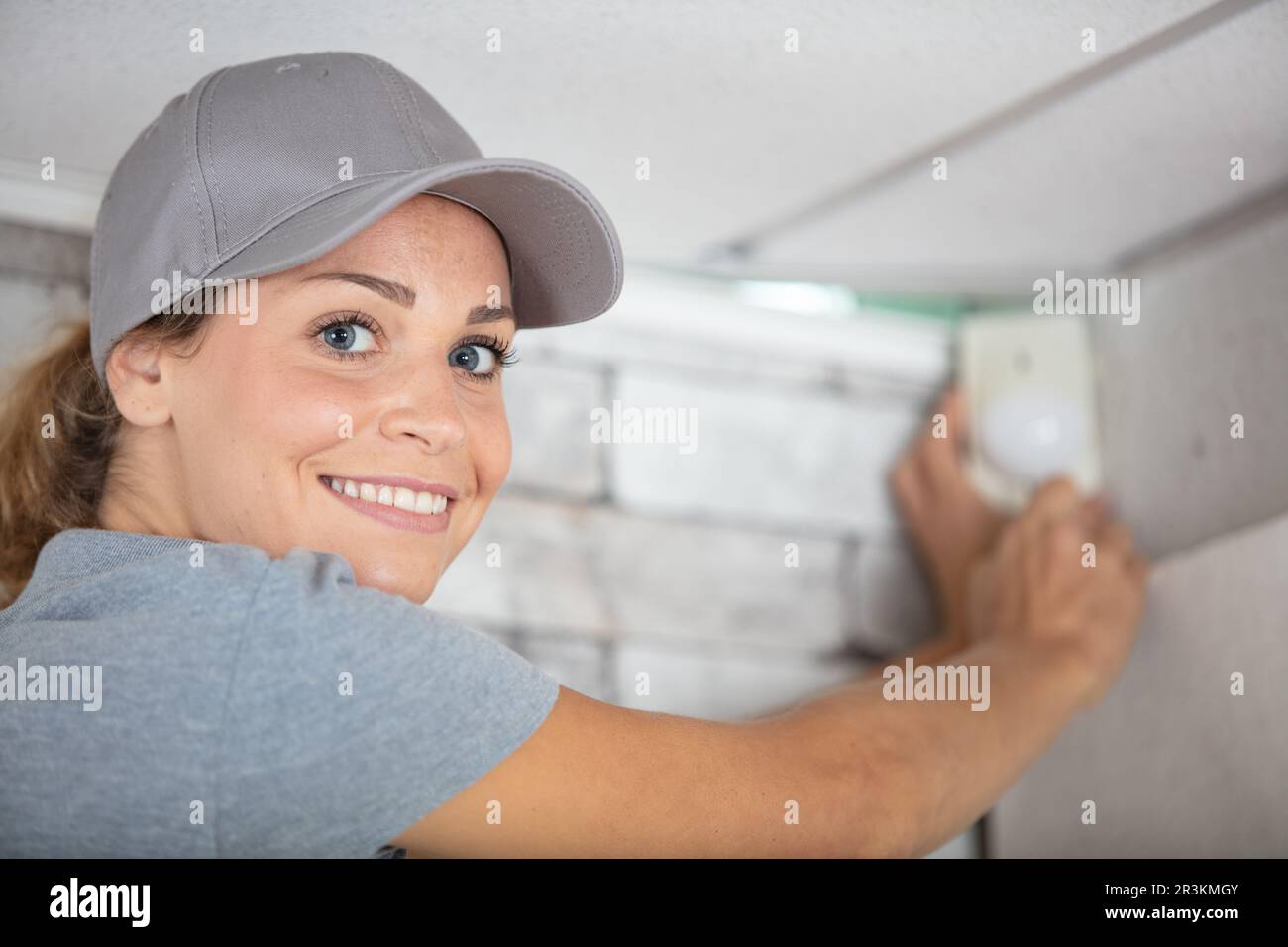 a woman is a cctv installer Stock Photo - Alamy