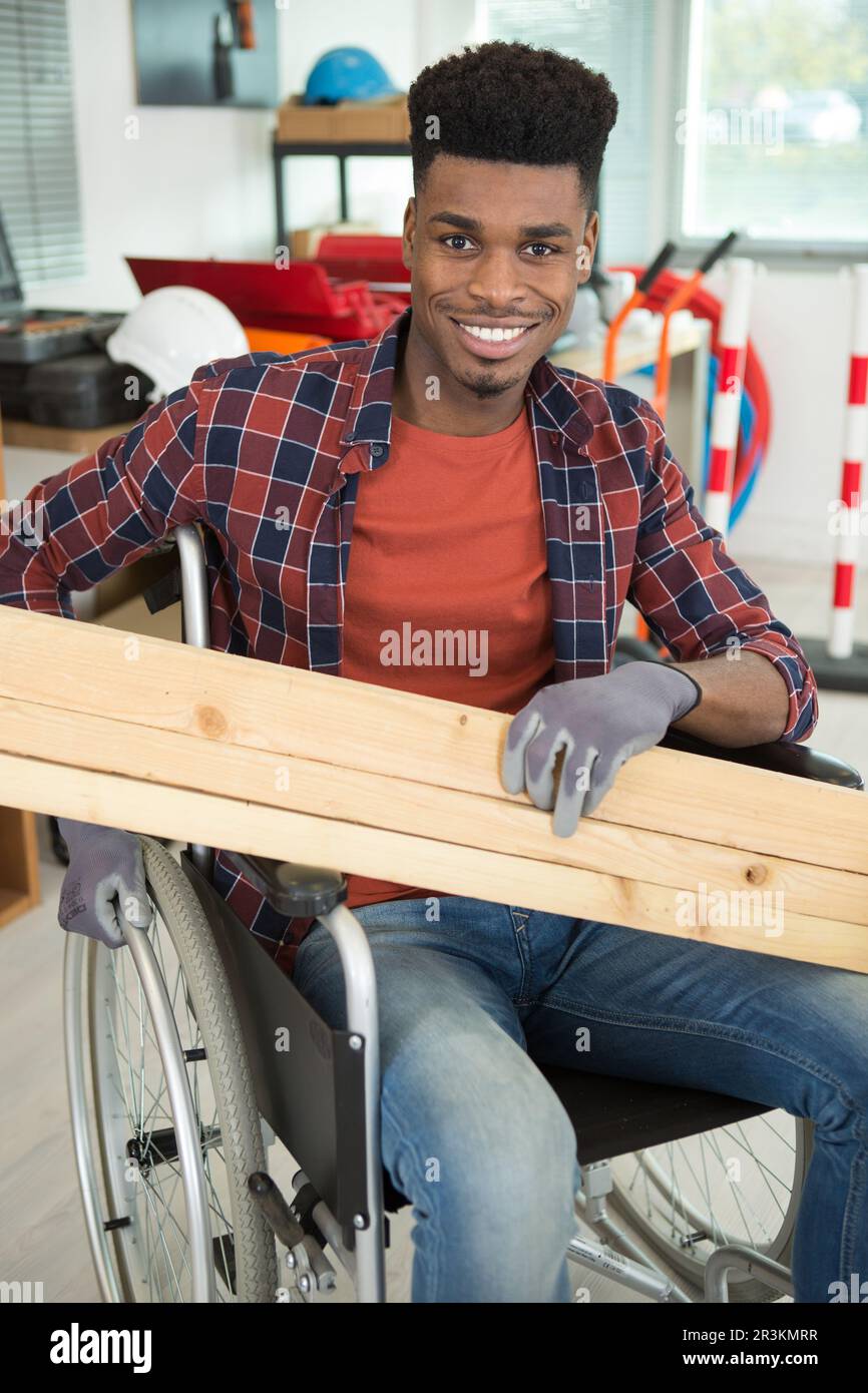 man in wheelchair working with wood Stock Photo - Alamy