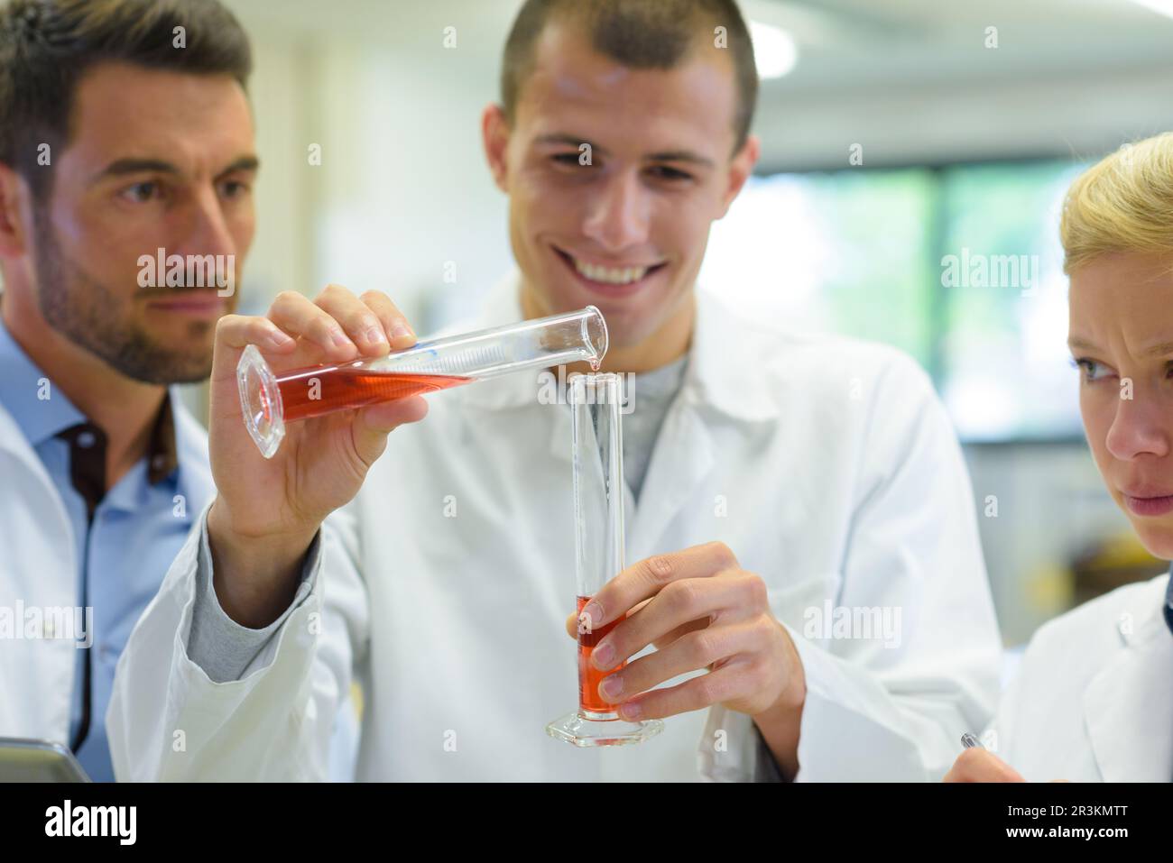 male intern mixing orange formula Stock Photo - Alamy