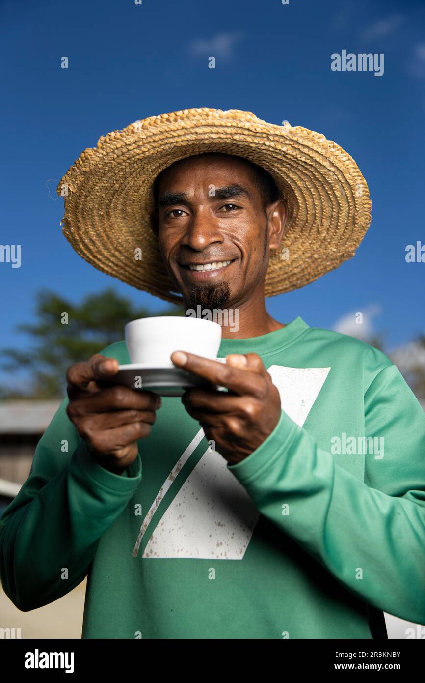 A Timorese holding a cup of coffee, Railaco, Timor-Leste Stock Photo ...