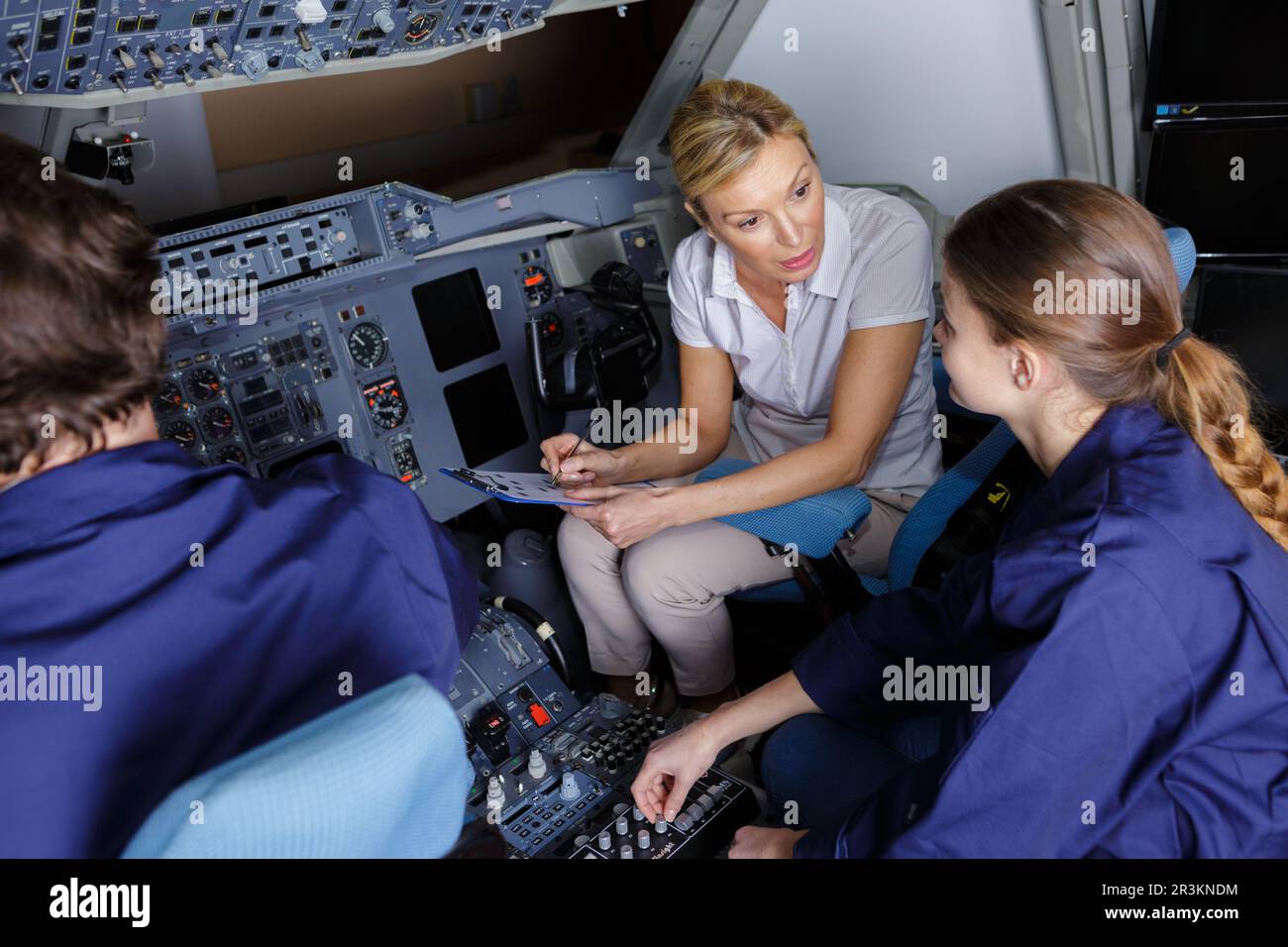 mature woman training students in aircraft cockpit Stock Photo - Alamy