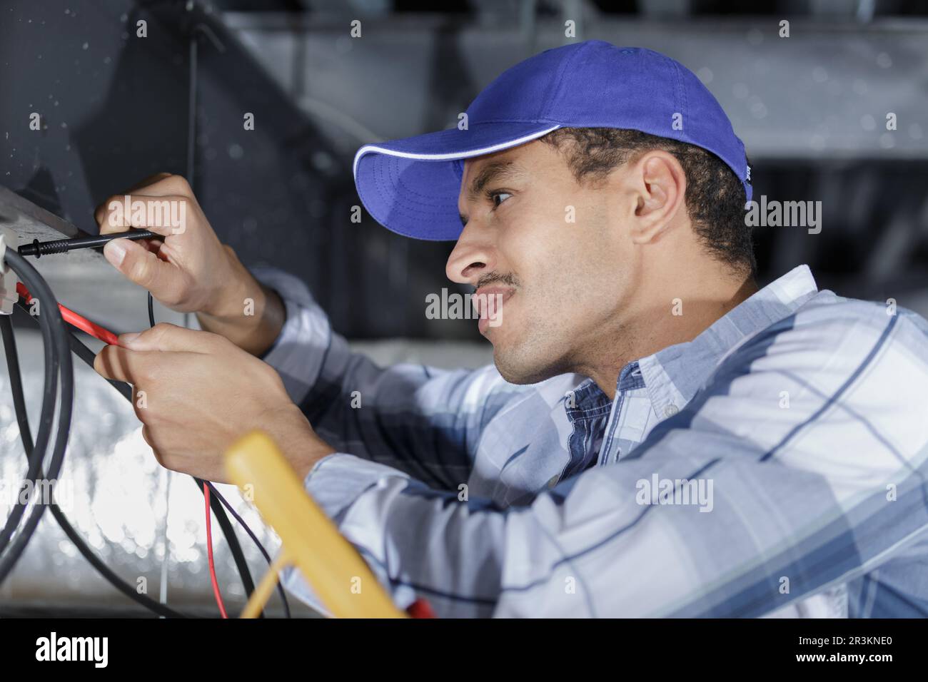 male electrician installing cables in ceiling Stock Photo - Alamy