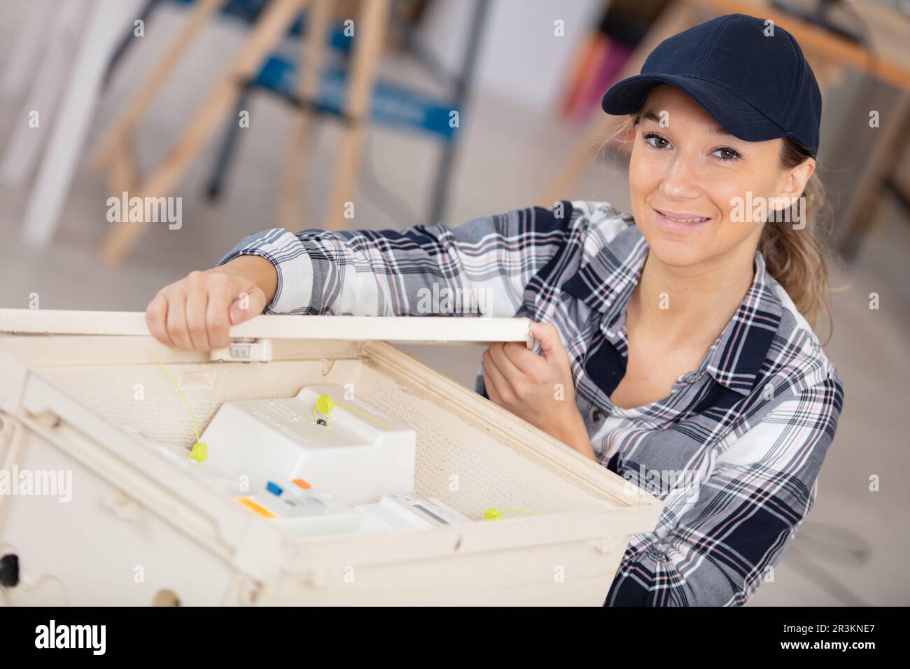 female tech repairing device at workplace Stock Photo - Alamy