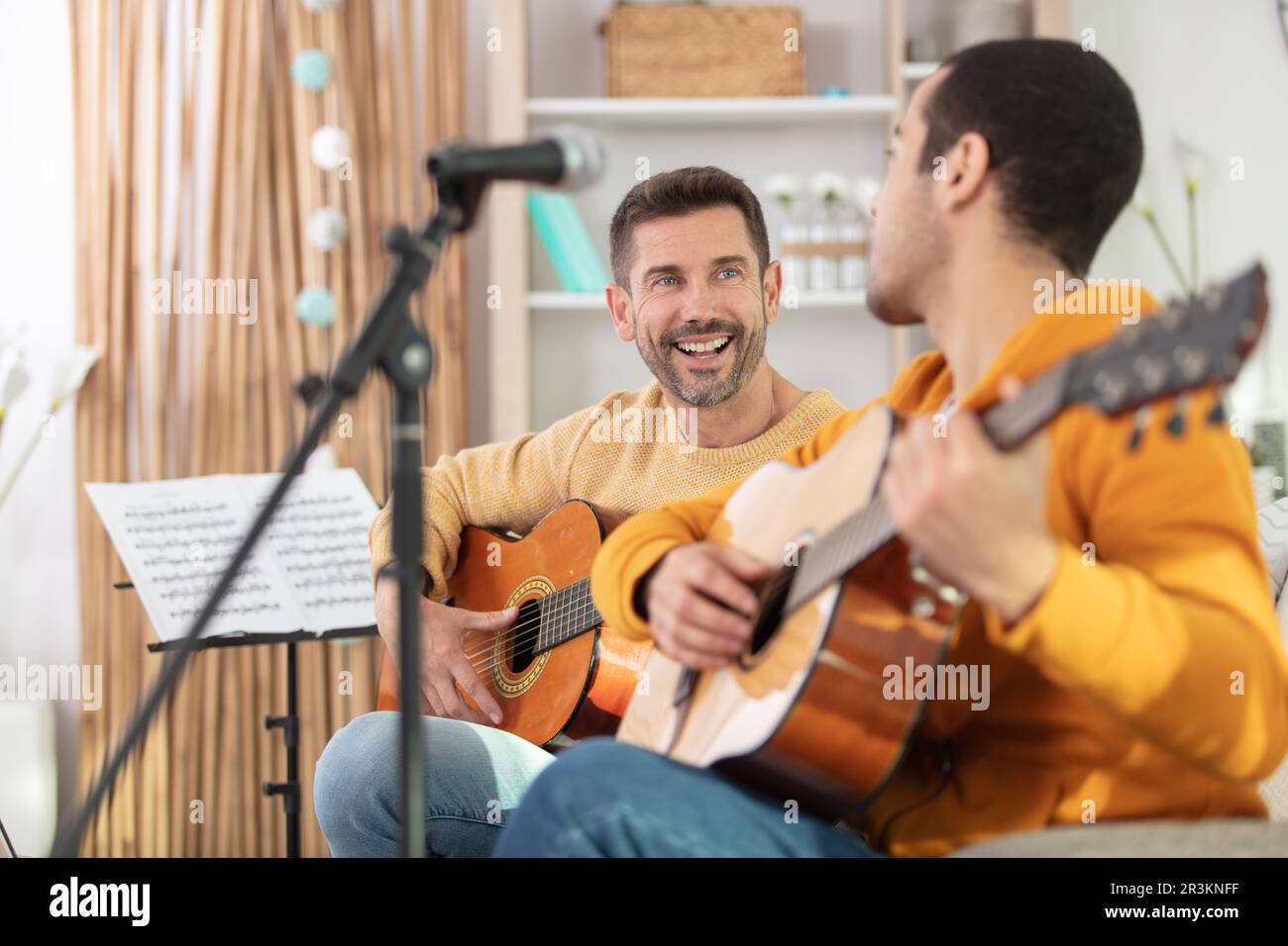 Music teacher teaching student guitar hi-res stock photography and ...