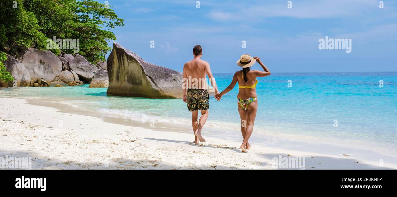Men and women on the tropical white beach with turqouse colored ocean of Similan Islands ...