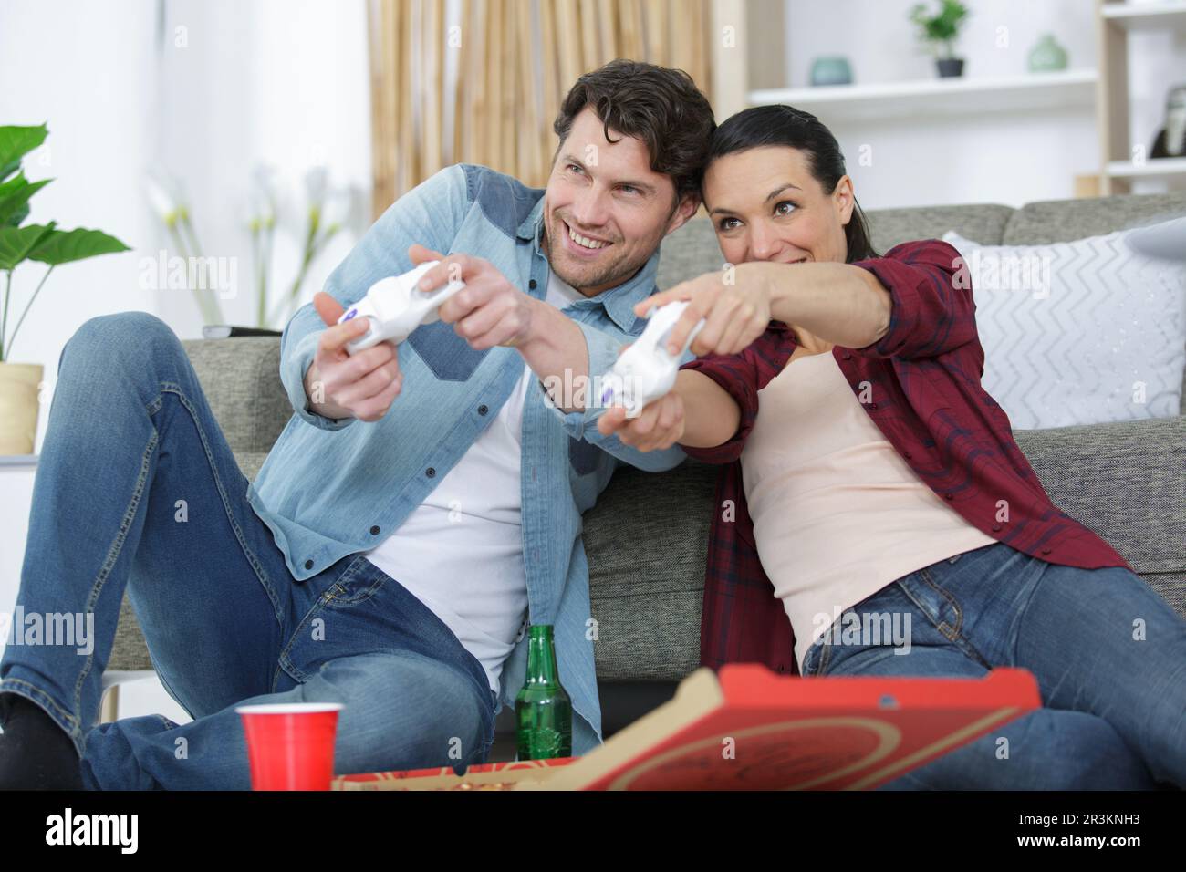 coupleplaying video games having fun at home closeup Stock Photo - Alamy