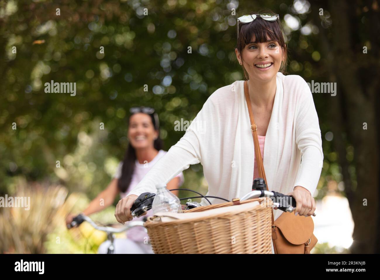 two friends on bikes outdoors smiling Stock Photo - Alamy