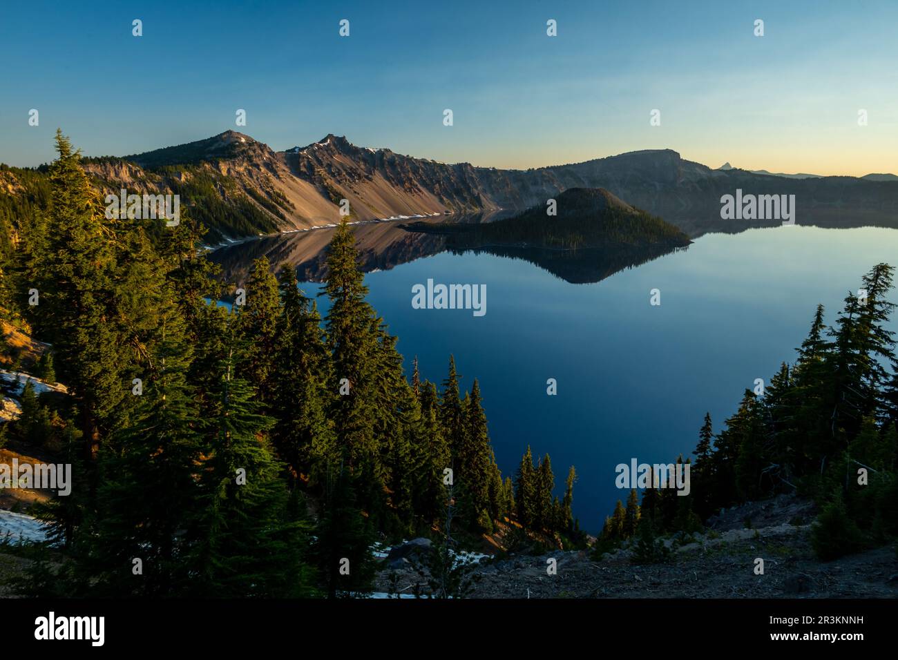 Wizard Island and Surrounding Cliffs Reflect In The MIrrored Surface of ...