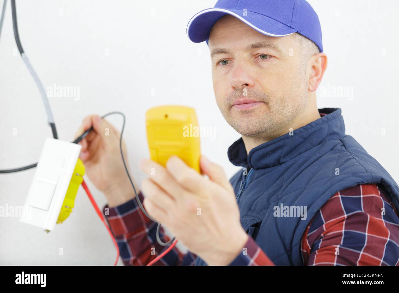 electrician at work measures the electric current Stock Photo - Alamy