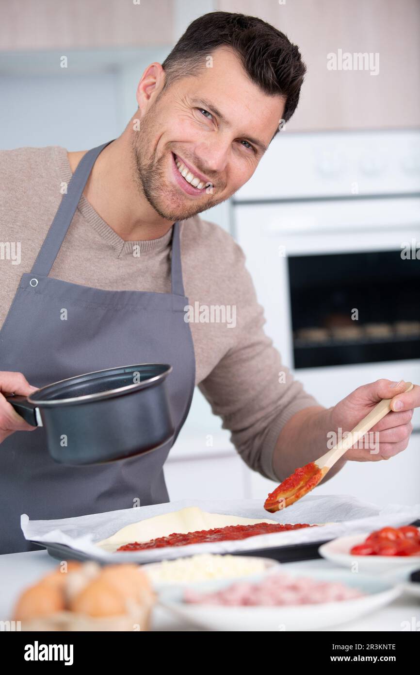 man making pizza in kitchen together Stock Photo - Alamy