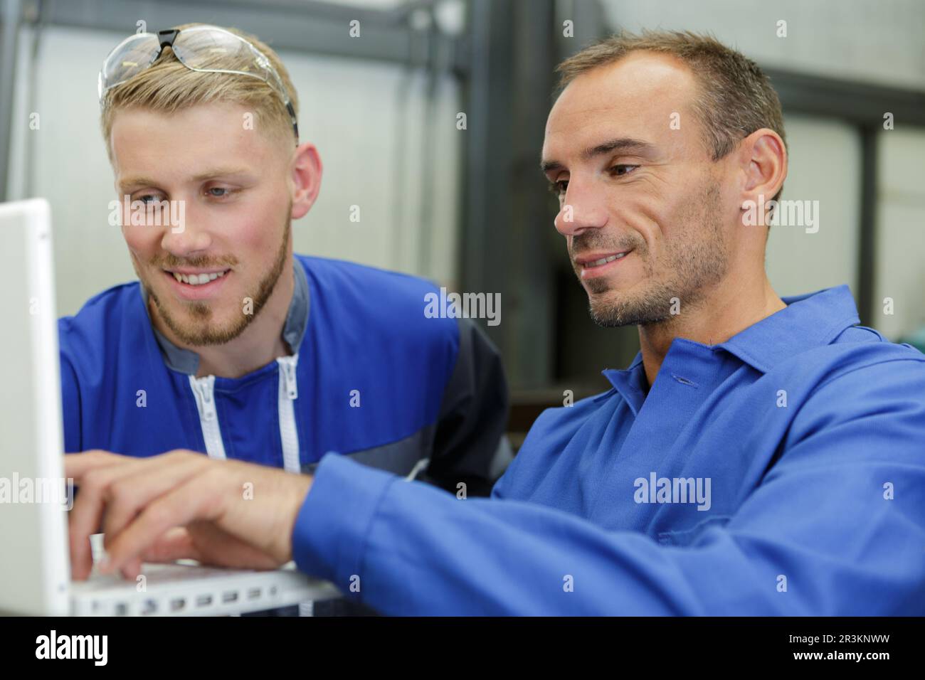 two mechanics work with the details of the car Stock Photo - Alamy