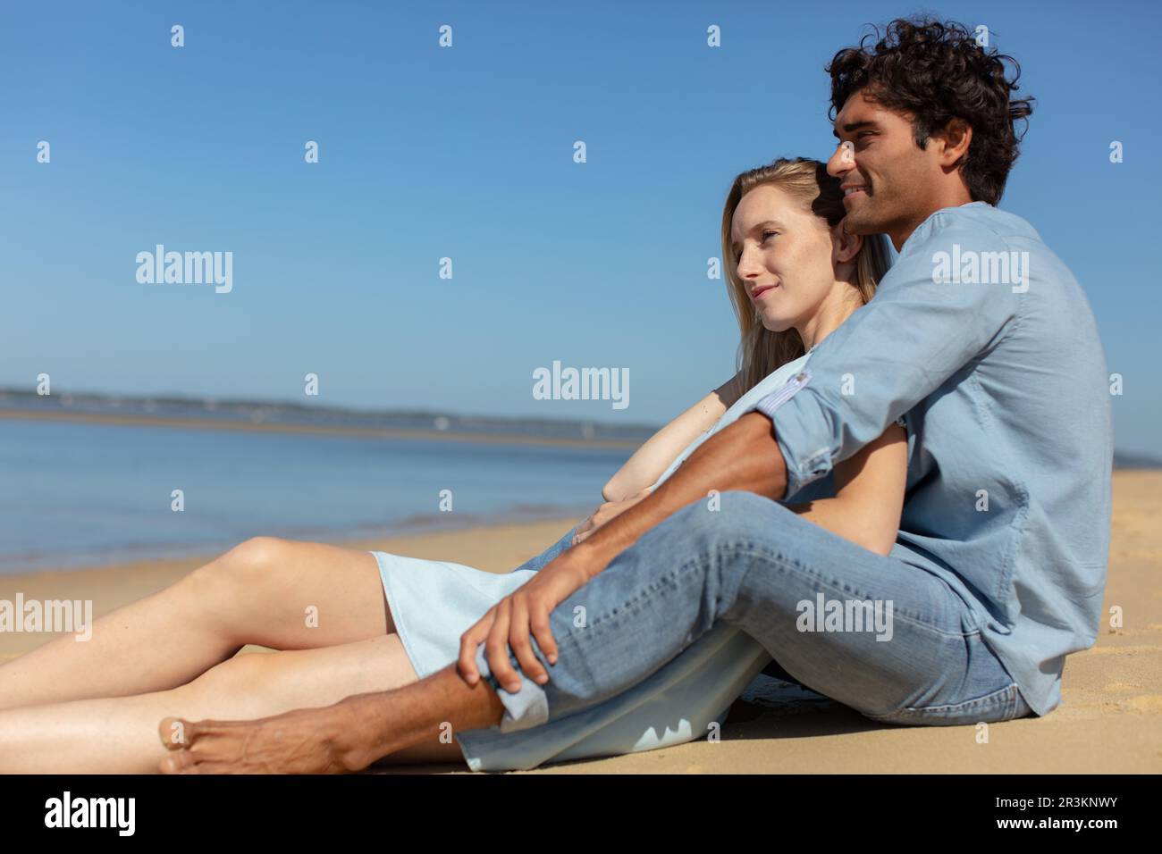 two friends seating on the beach together Stock Photo - Alamy