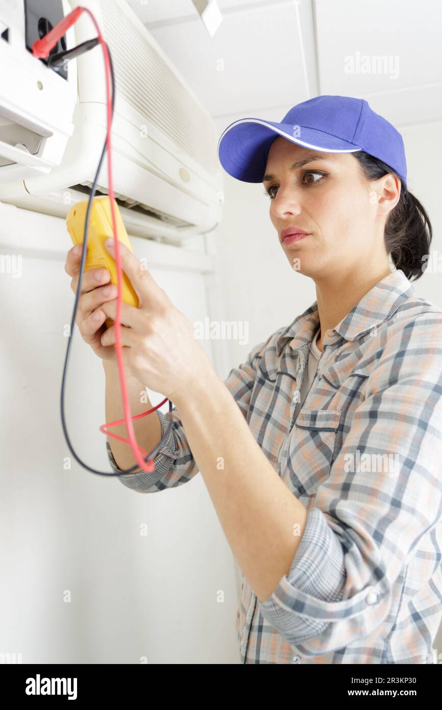 Electrician checking socket voltage using hi-res stock photography and ...
