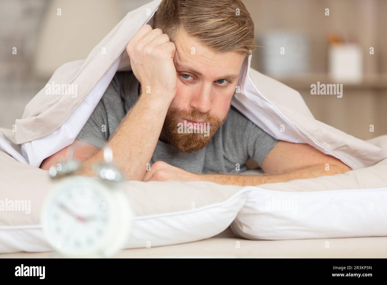 monday morning again - man unhappy to wake up Stock Photo - Alamy