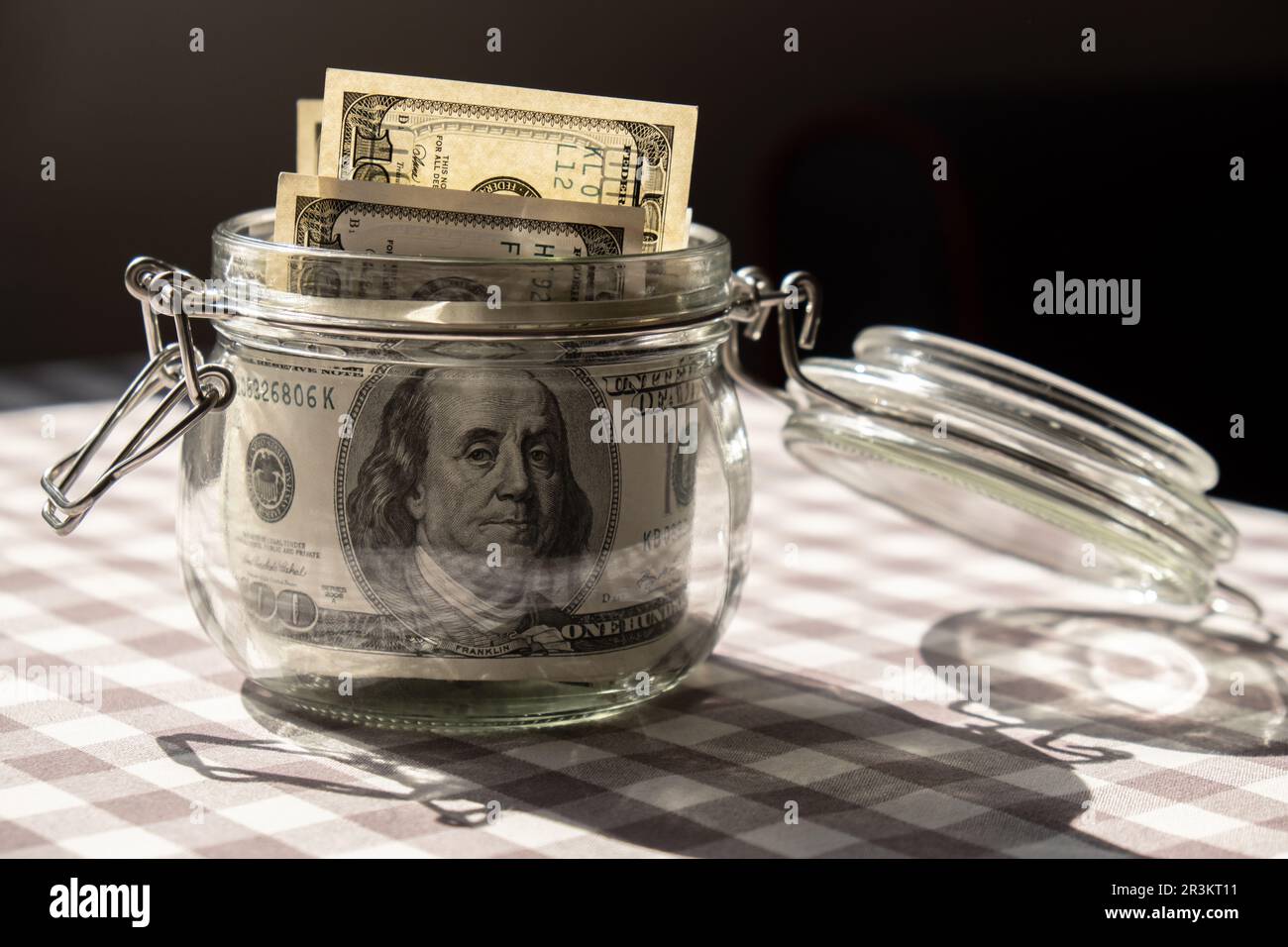 Dollar banknote saving money in glass jar. Consumption and economy ...