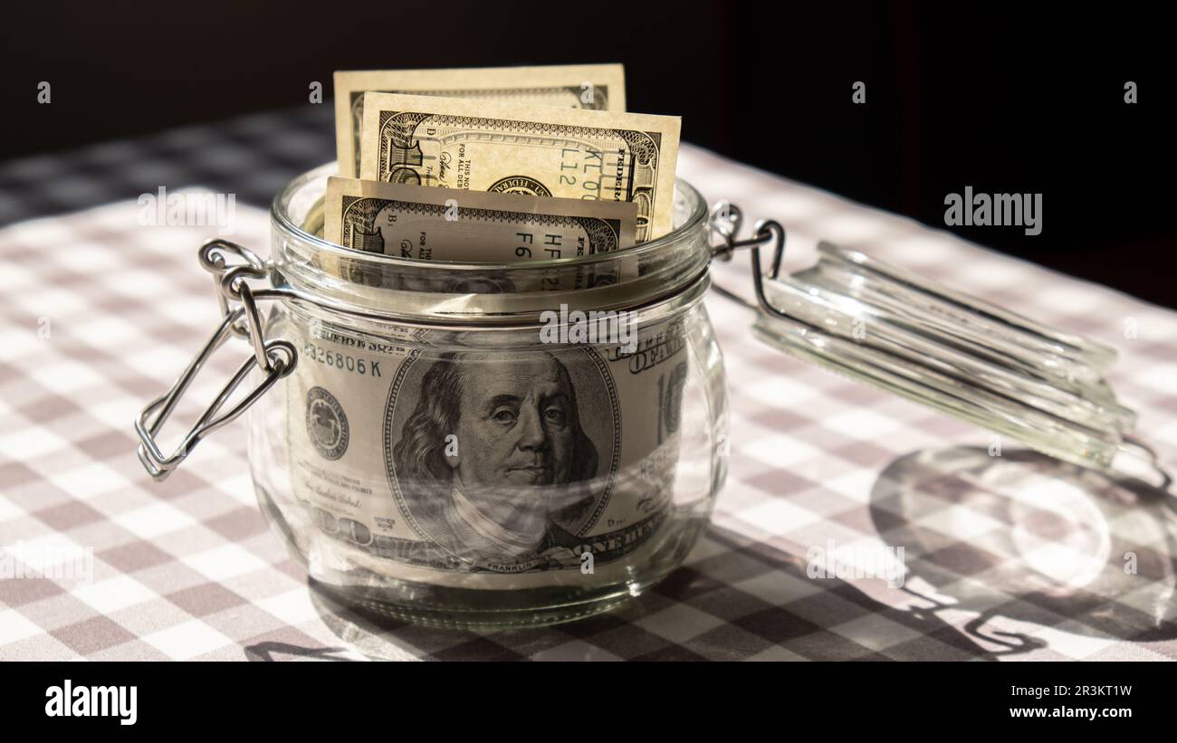 Dollar banknote saving money in glass jar. Consumption and economy ...