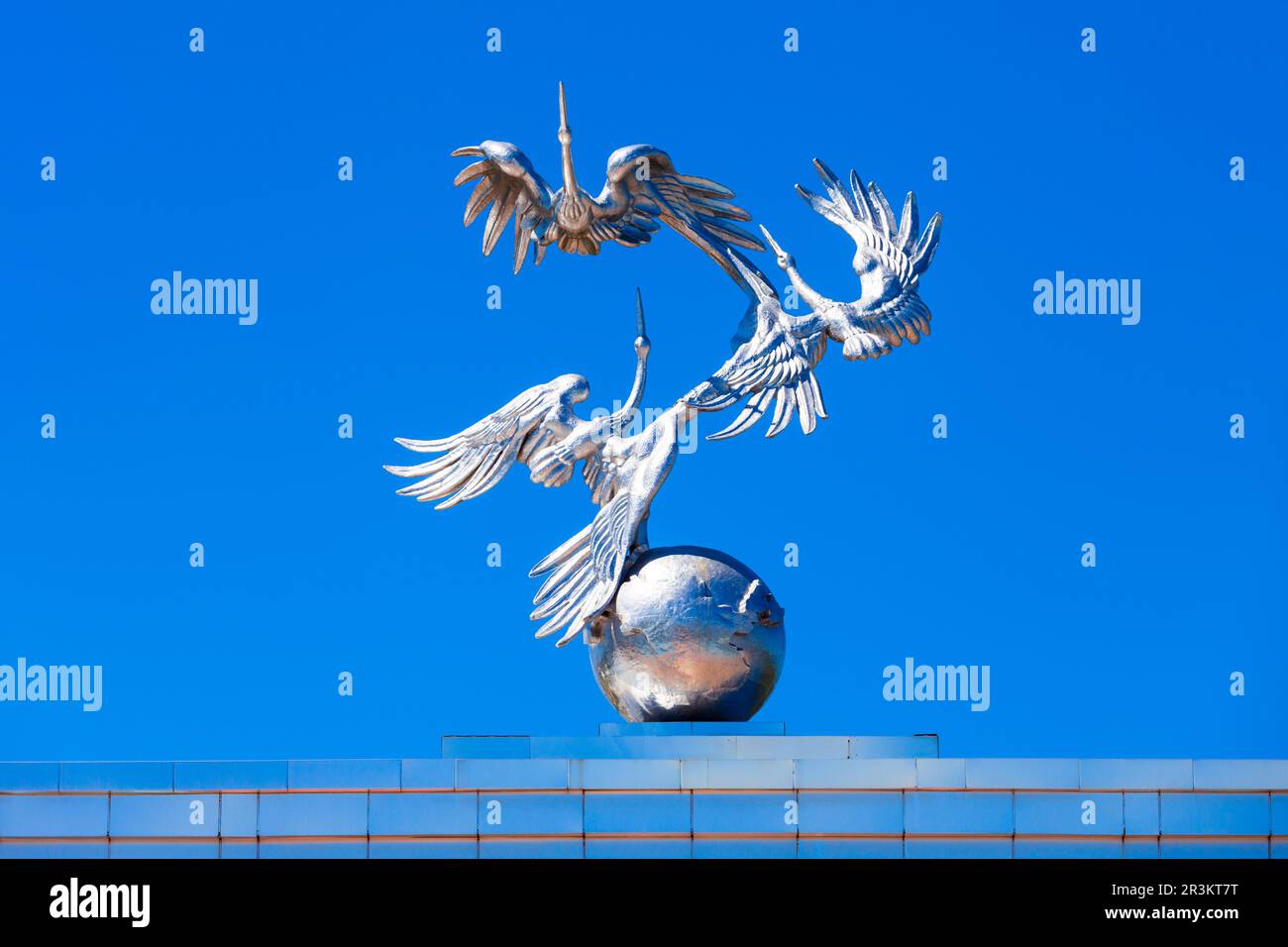 Tashkent, Uzbekistan - April 11, 2021: Storks flying over the globe in ...