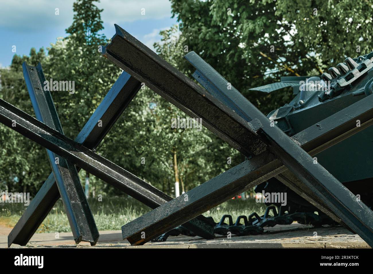 Anti-tank hedgehogs and tank closeup and peaceful background. Monument ...
