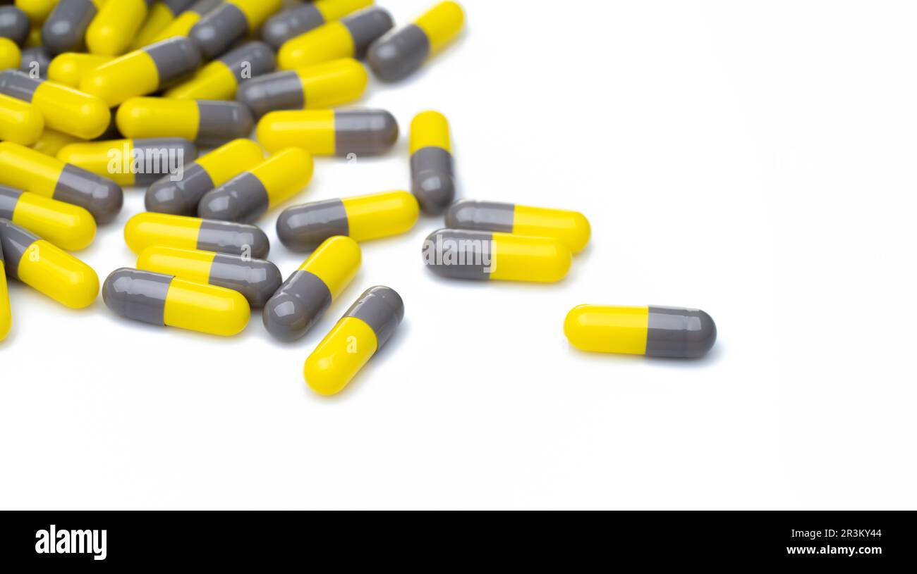 Yellow and gray probiotic capsule pill on white background. Probiotic ...