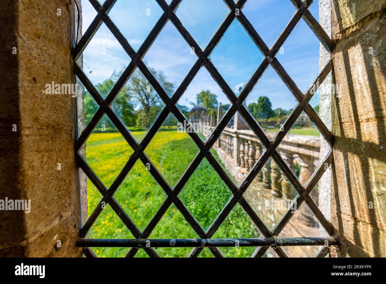 Montacute, UK. Sunday 21 May 2023. Old lead windows looking out to a ...