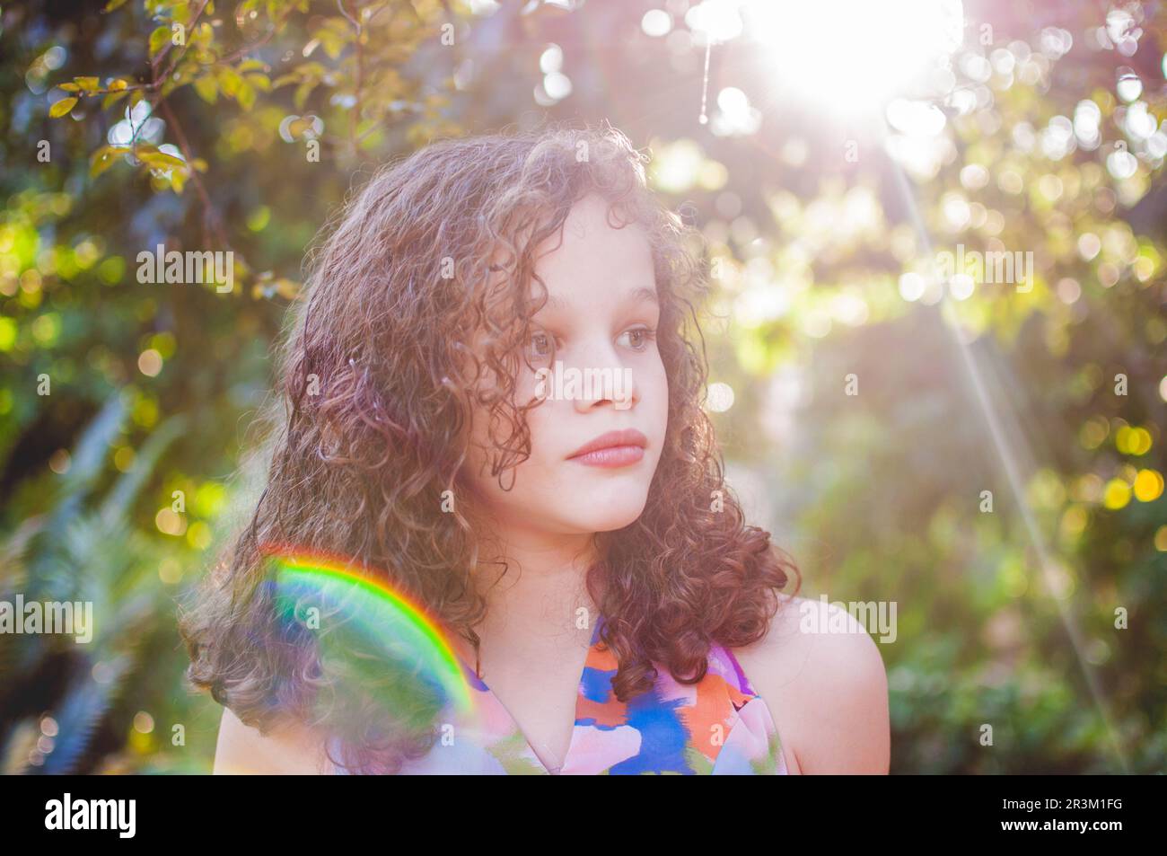 Portrait of beautiful girl with curly hair. Sunlight with flare Stock ...