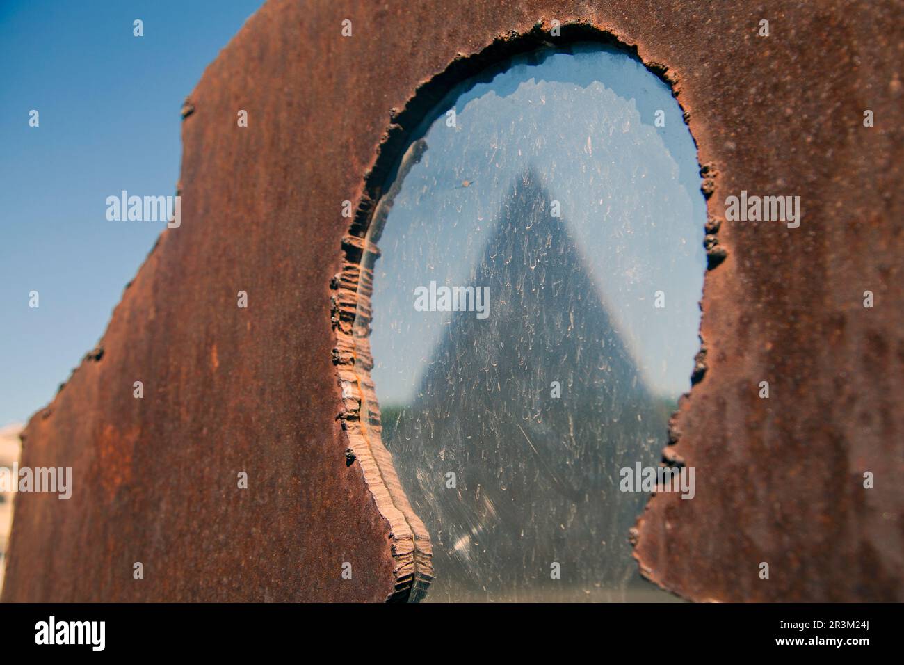 A view of The pyramid of Cestius in a rusty metal frame, is a Roman Era ...