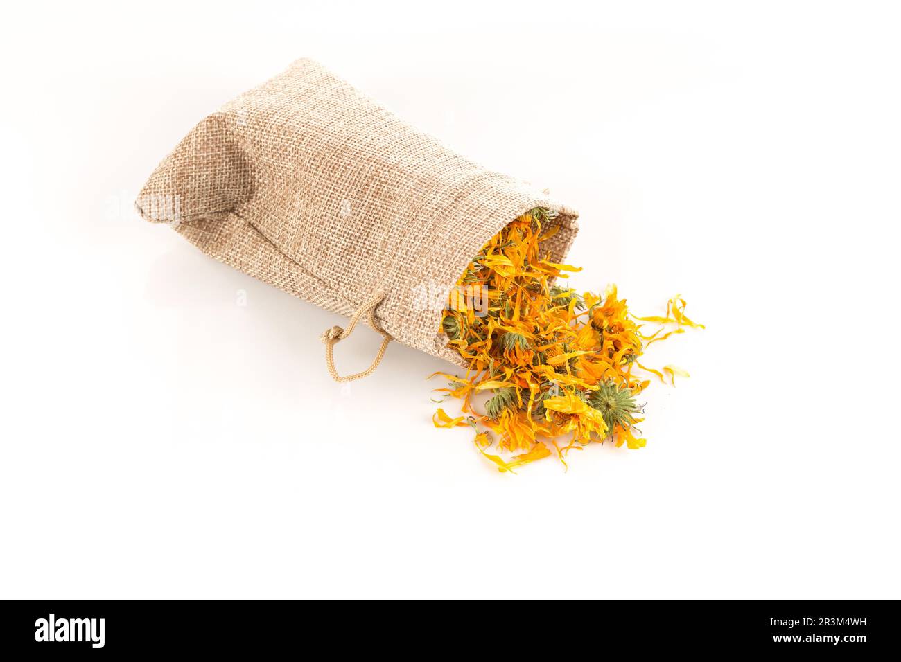 Calendula flowewr tea for infusion in sack on white background Stock ...