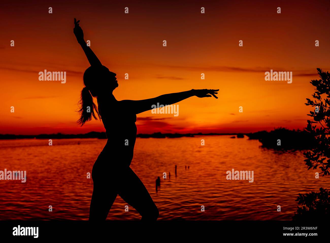 A Lovely Latin Model PosesAs The Sun Rises In The Caribbean Stock Photo ...