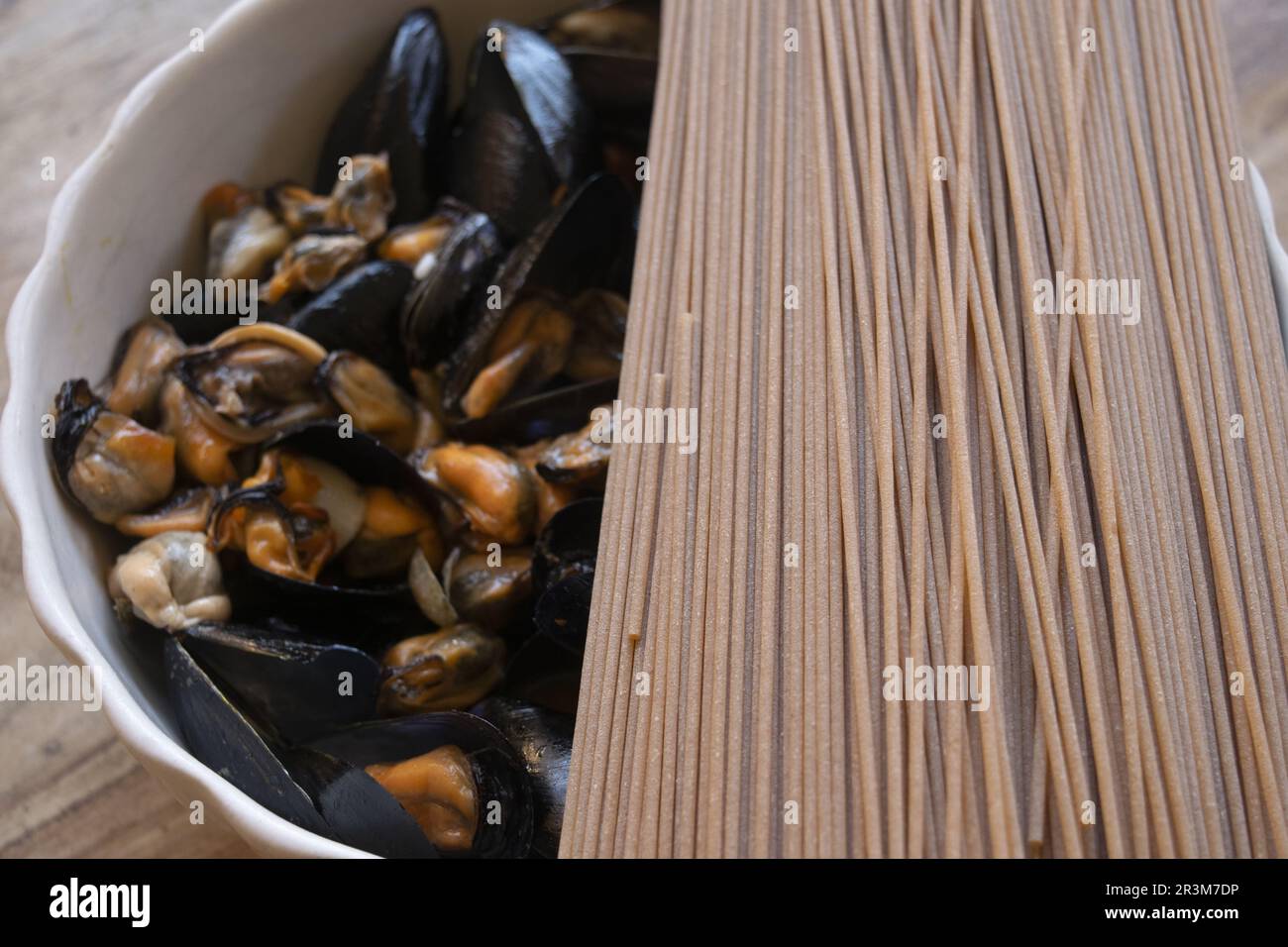 wholemeal spaghetti placed on a bowl full of mussel soup Stock Photo ...