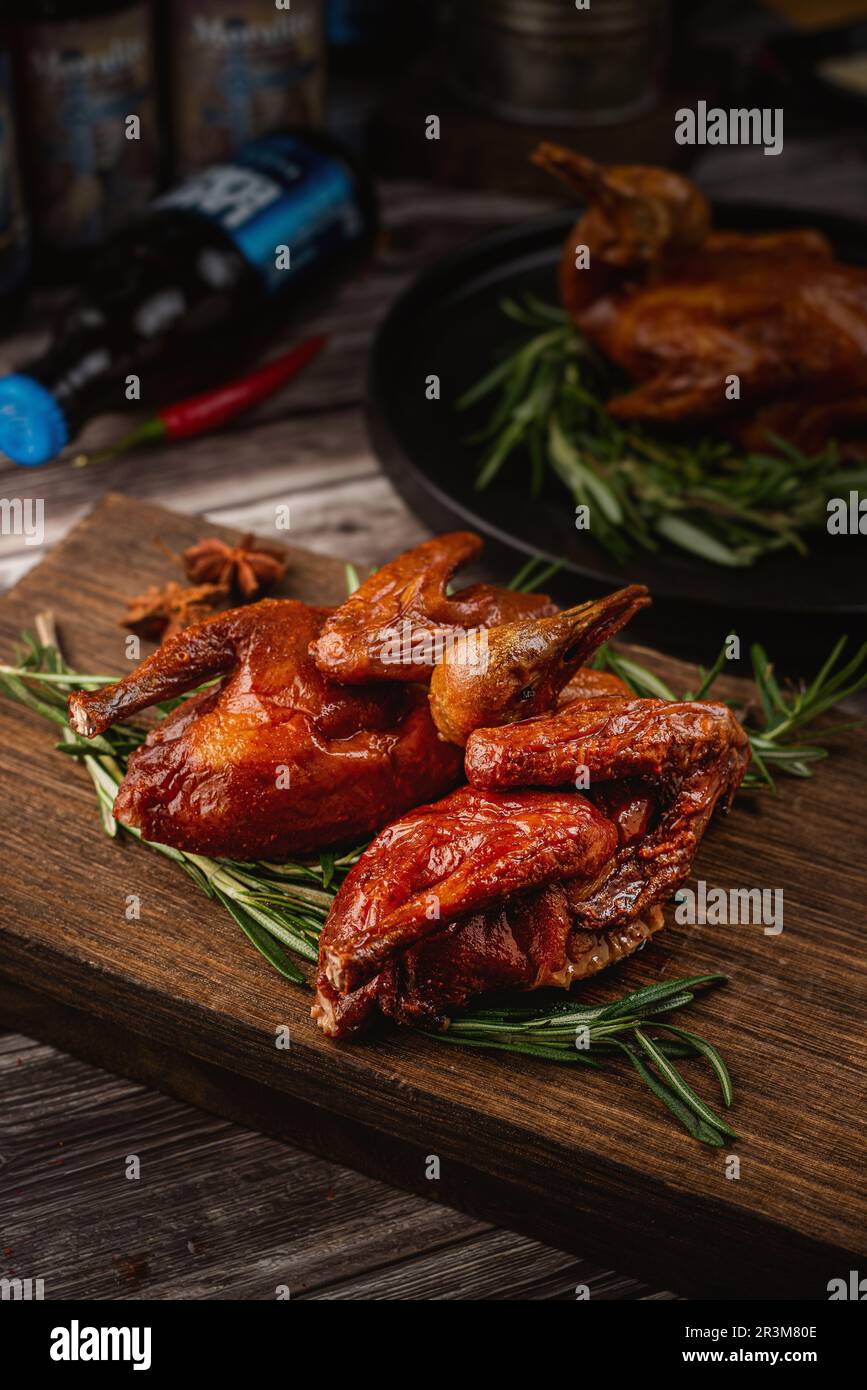 Traditional Cantonese grilled pigeon on a white porcelain plate，Crispy ...