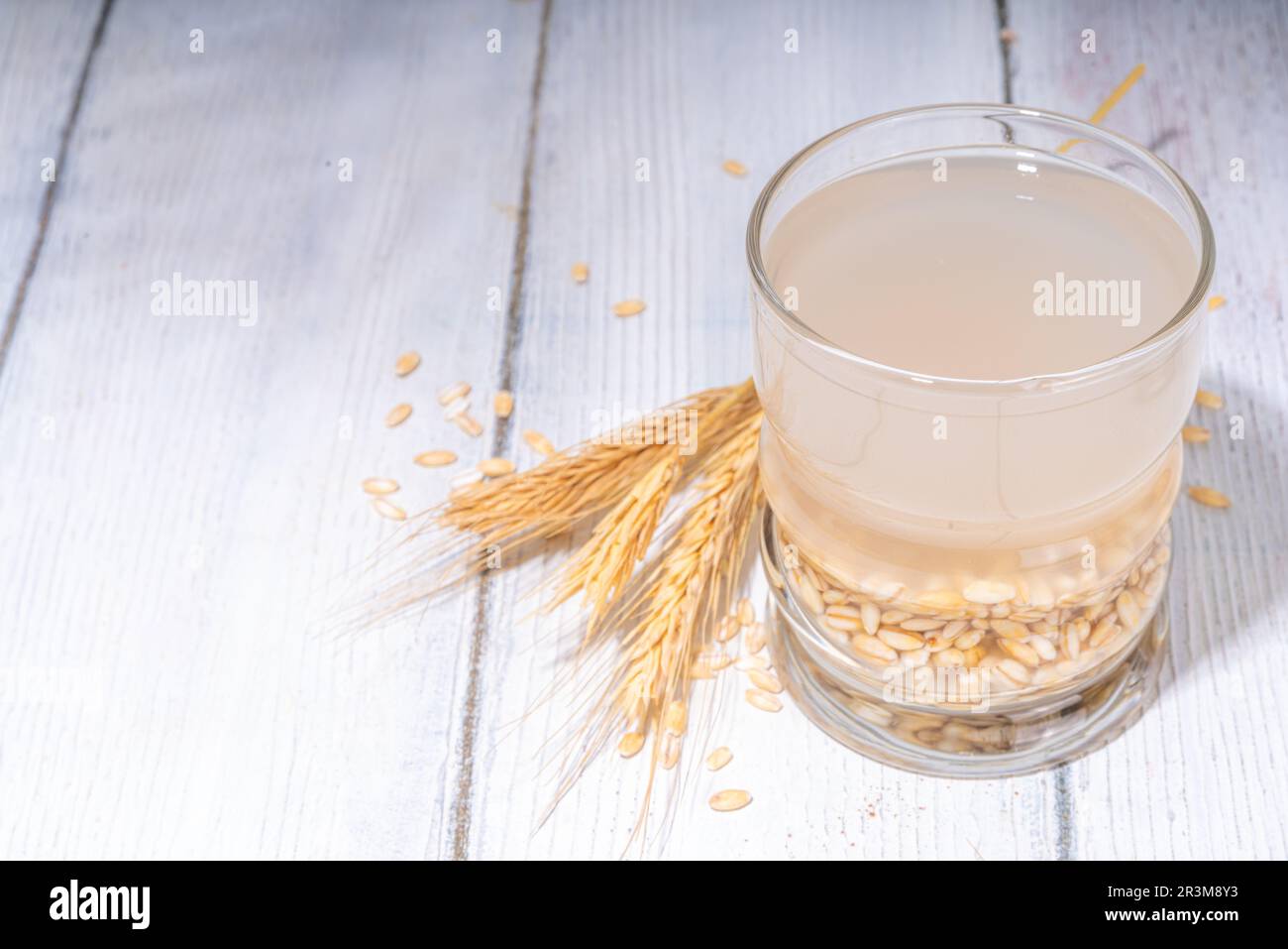 Simple barley orzo infused water drink in glass, with raw and cooked ...