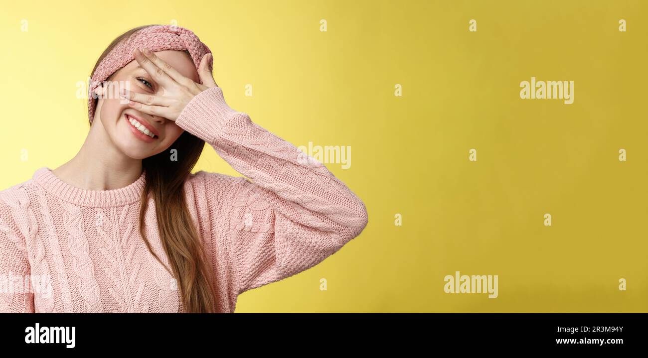 Blushing cute girl feeling positive, smiling happy joyful covering eyes ...