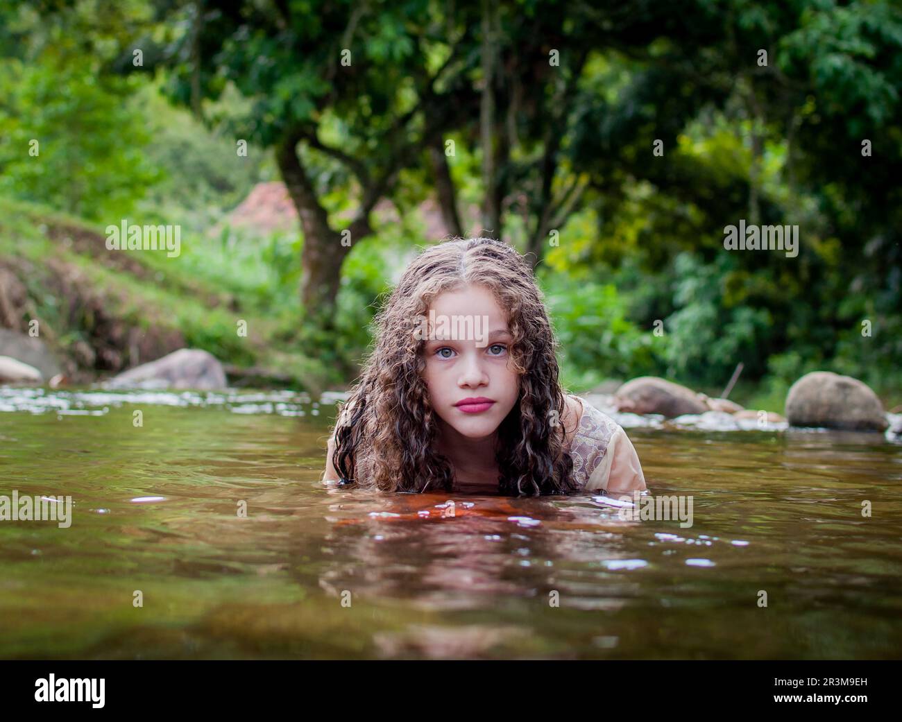 Portrait of beautiful girl immersed in river Stock Photo - Alamy