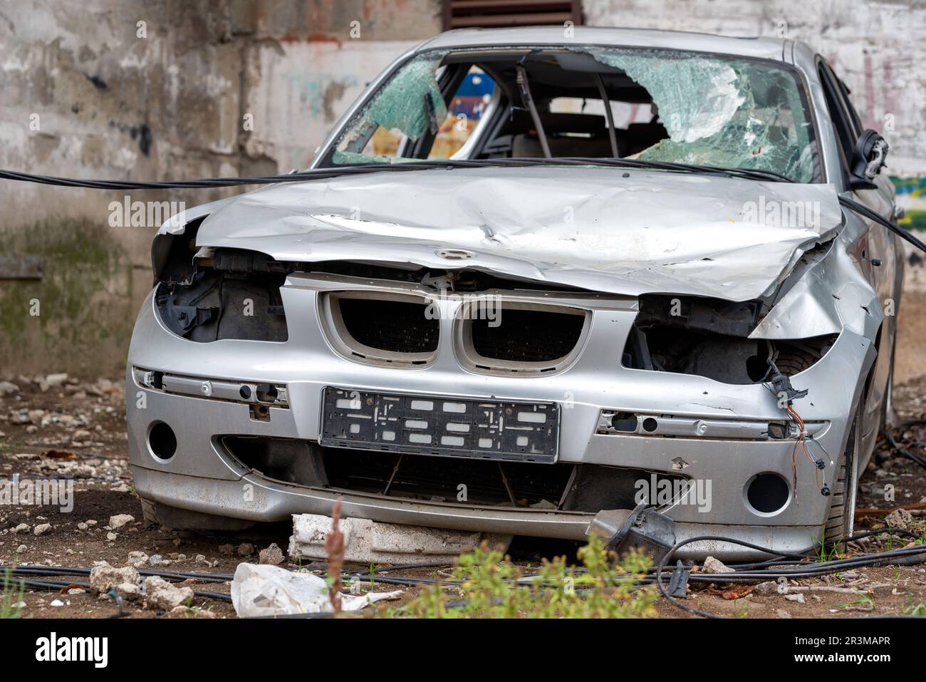 abandoned car broken by marauders on a city street in Ukraine war with ...