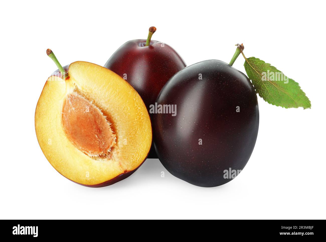 Whole and cut ripe plums on white background Stock Photo - Alamy