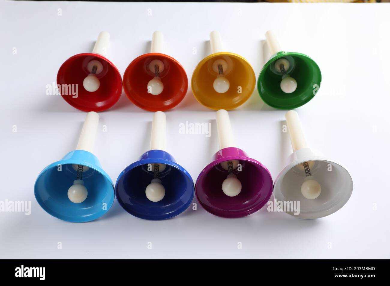 Set of bright metal hand bells on white background. Montessori musical ...